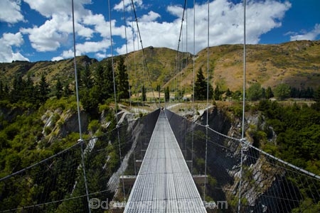 Mountain bikers high above the Arrow River on Edgar suspension bridge ...
