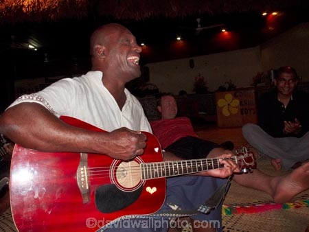 Fijian man performs traditional fijian songs on guitar at Crusoes ...